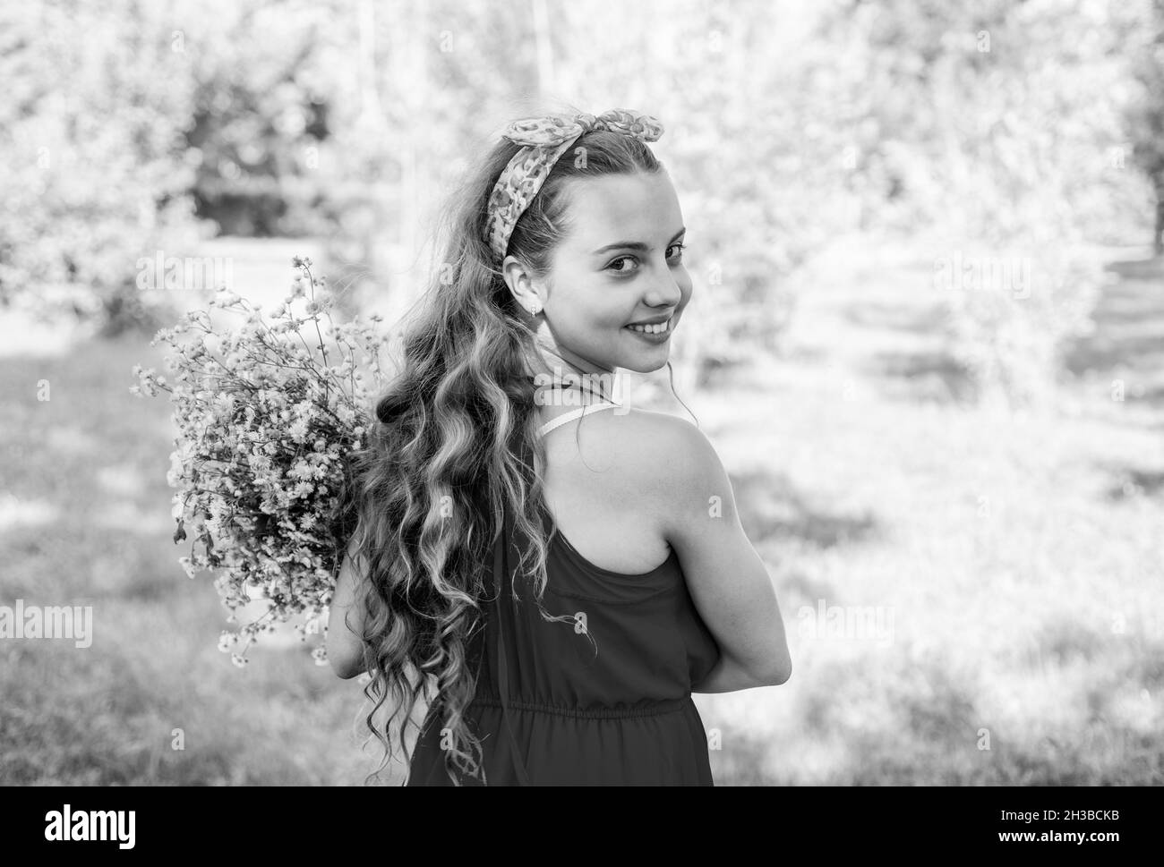 Time to have adventure. Happy girl smile with flowers on natural ...