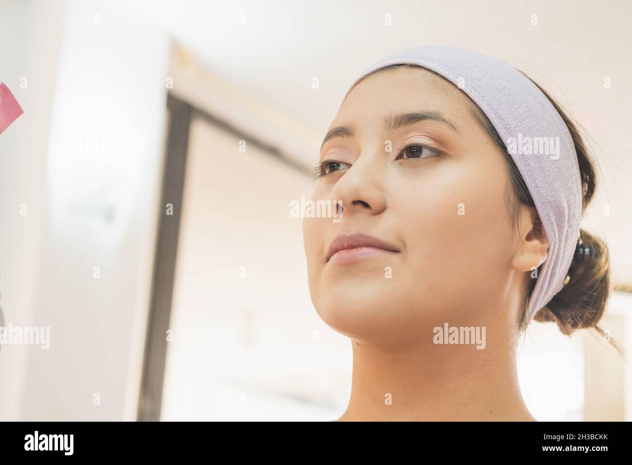 Young woman getting ready to put on makeup for a special event. In a ...