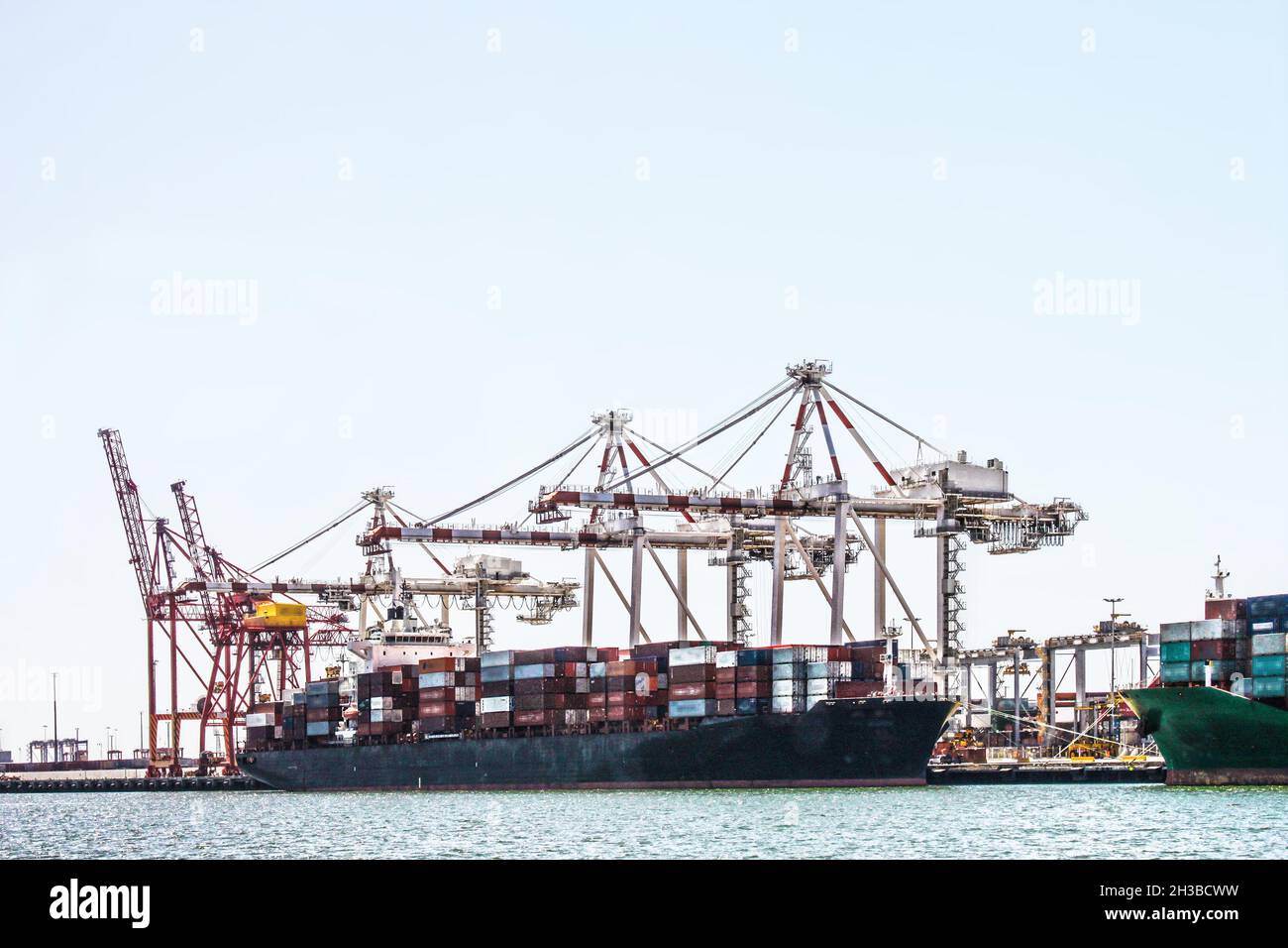 Container ship being loaded or unloaded by giant cranes on Brisbane ...
