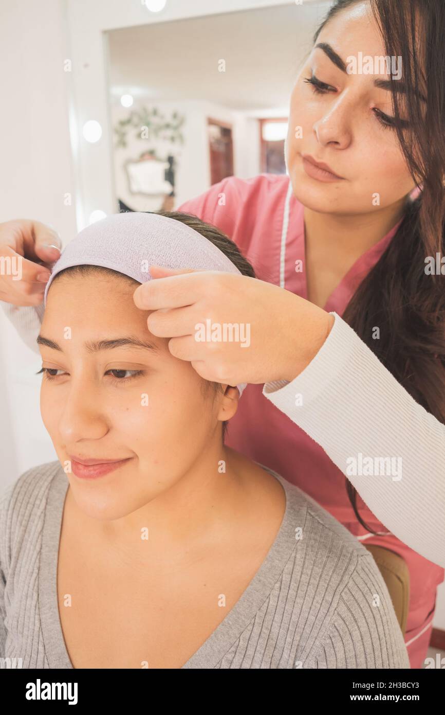 Young woman getting ready to put on makeup for a special event. In a ...