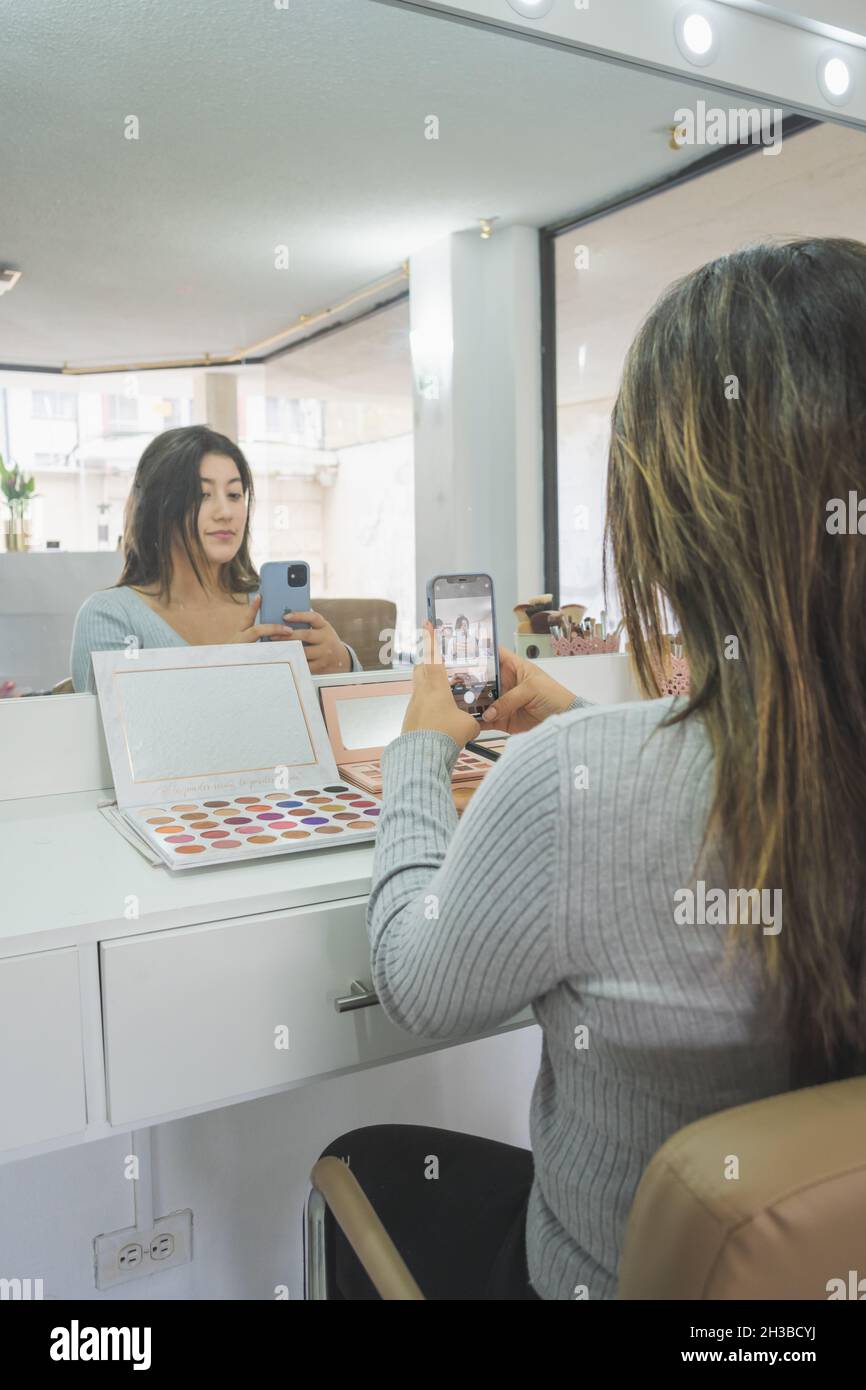 Young woman getting ready to put on makeup for a special event. In a ...