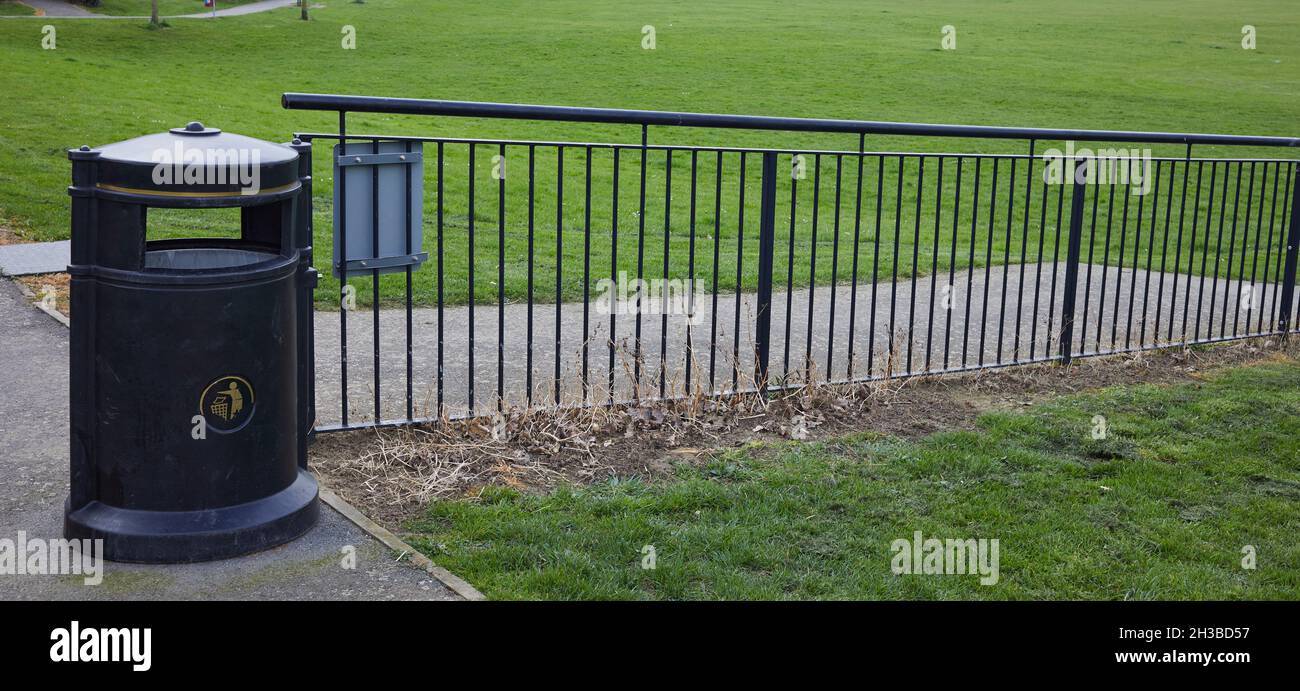 Rubbish bin and railings on recreation ground Stock Photo - Alamy