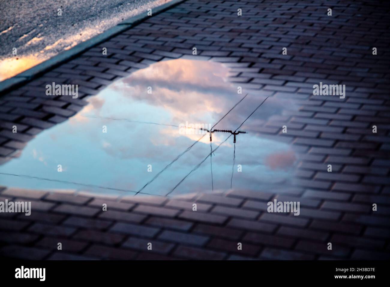 Blue sky is reflected in the puddle hi-res stock photography and images ...
