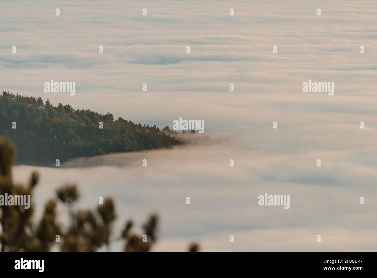Thick clouds layer with small hill Stock Photo - Alamy