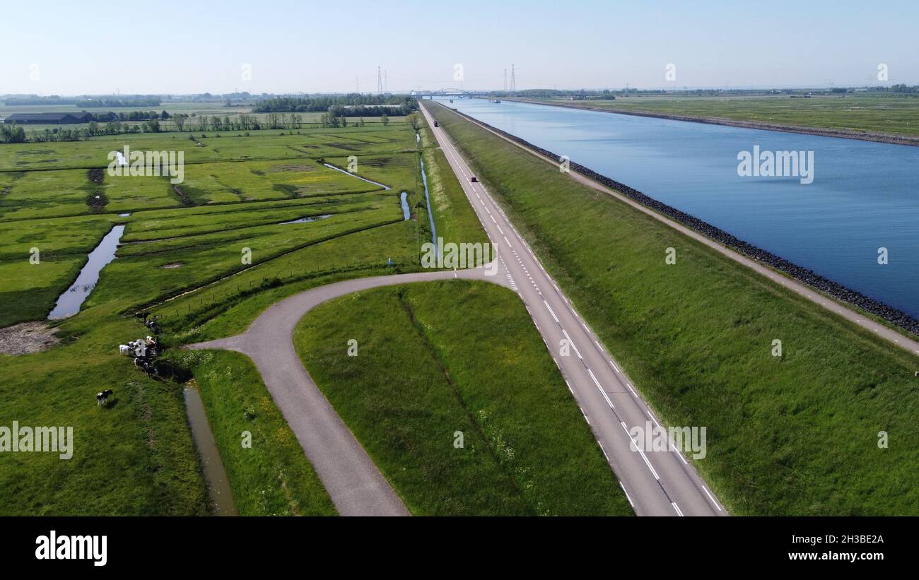 Aerial view on green polders, meadows and water transportion channel in ...