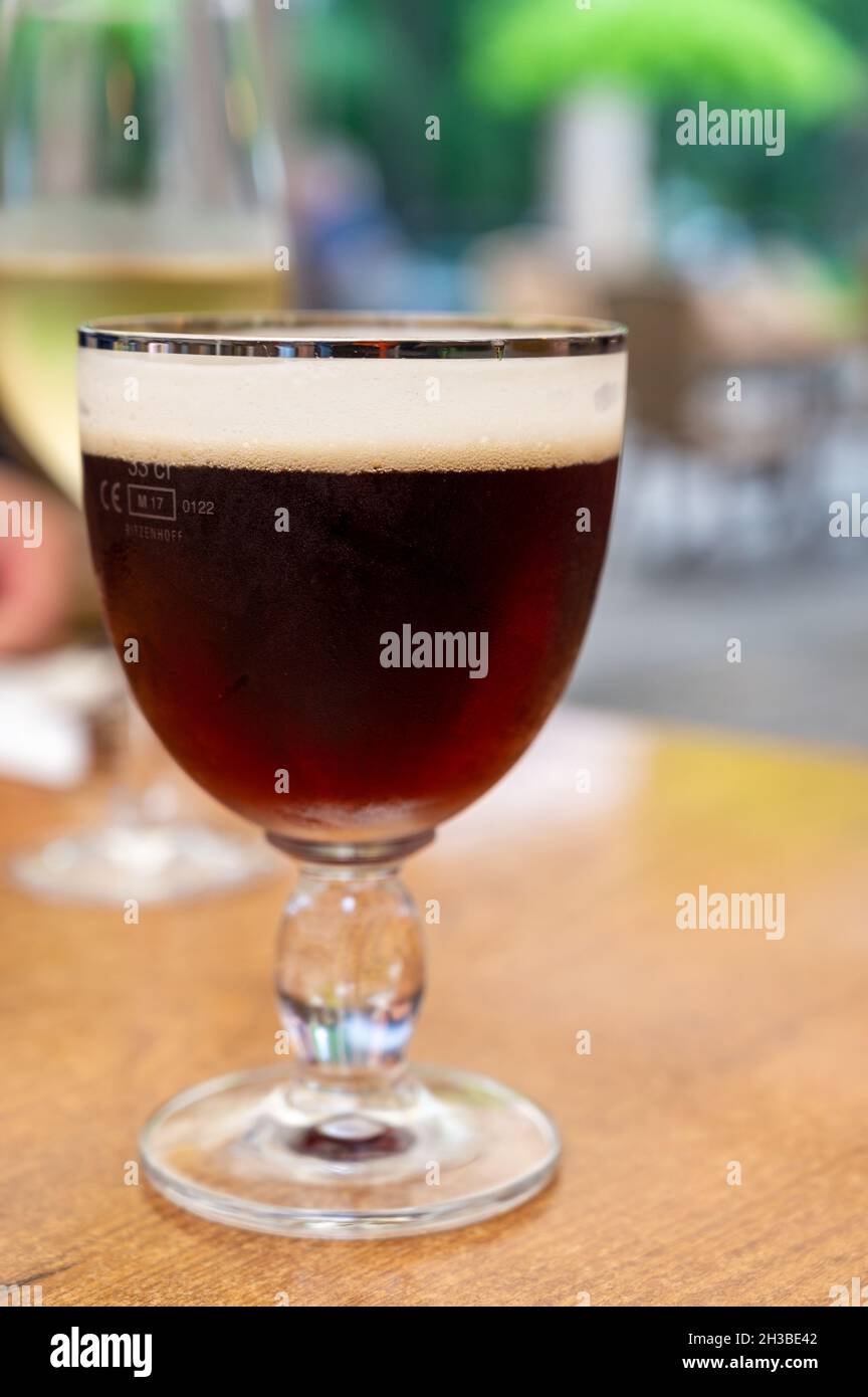 Glass of dark tasty Belgian dubbel brown beer from abbey brewery served ...