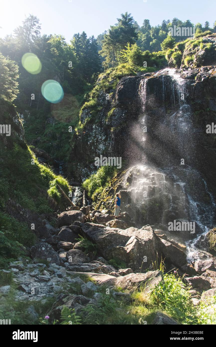 A hiker admires the Cascade D'Ars waterfall in the Pyrenees Stock Photo ...