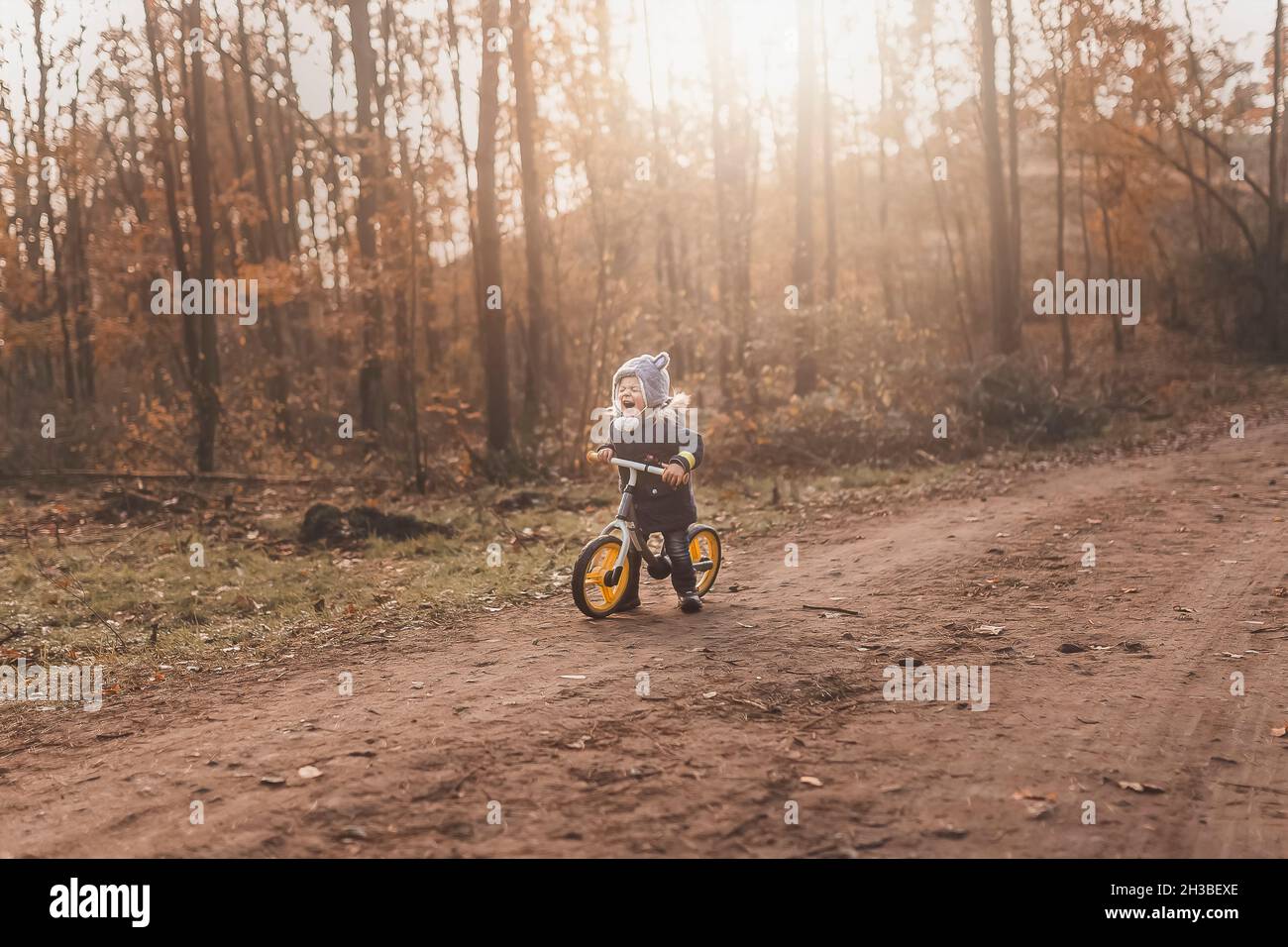 Small tired and overwhelmed boy screaming in forest while sittin Stock ...
