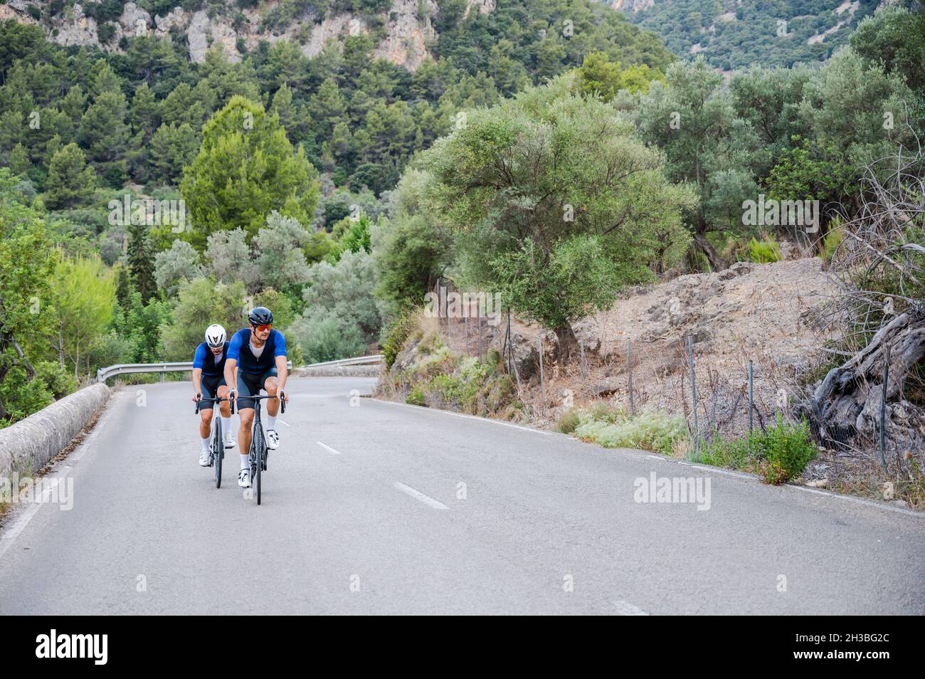 Two cyclists training on a mountain road Stock Photo - Alamy