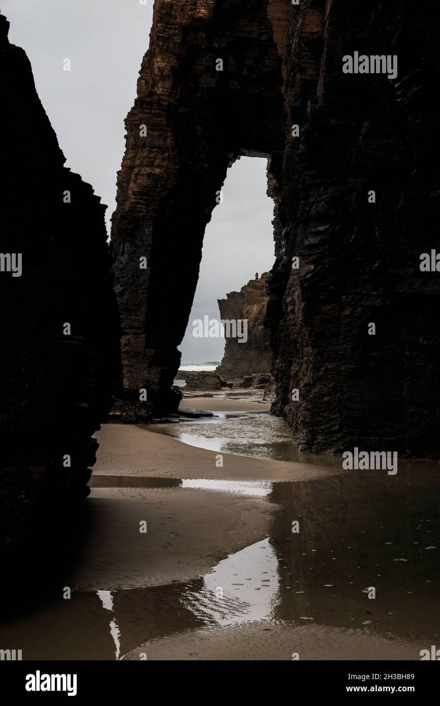 Vertical shot of a natural stone arch at the Beach of the Cathedrals ...