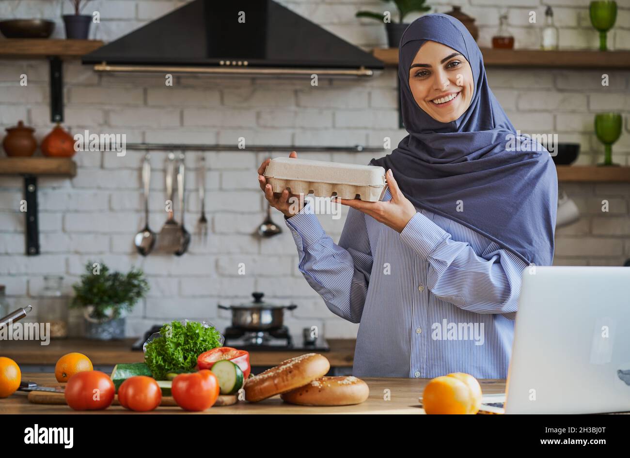 Lovely Muslim lady showing a tray of eggs and giving a smile to the ...