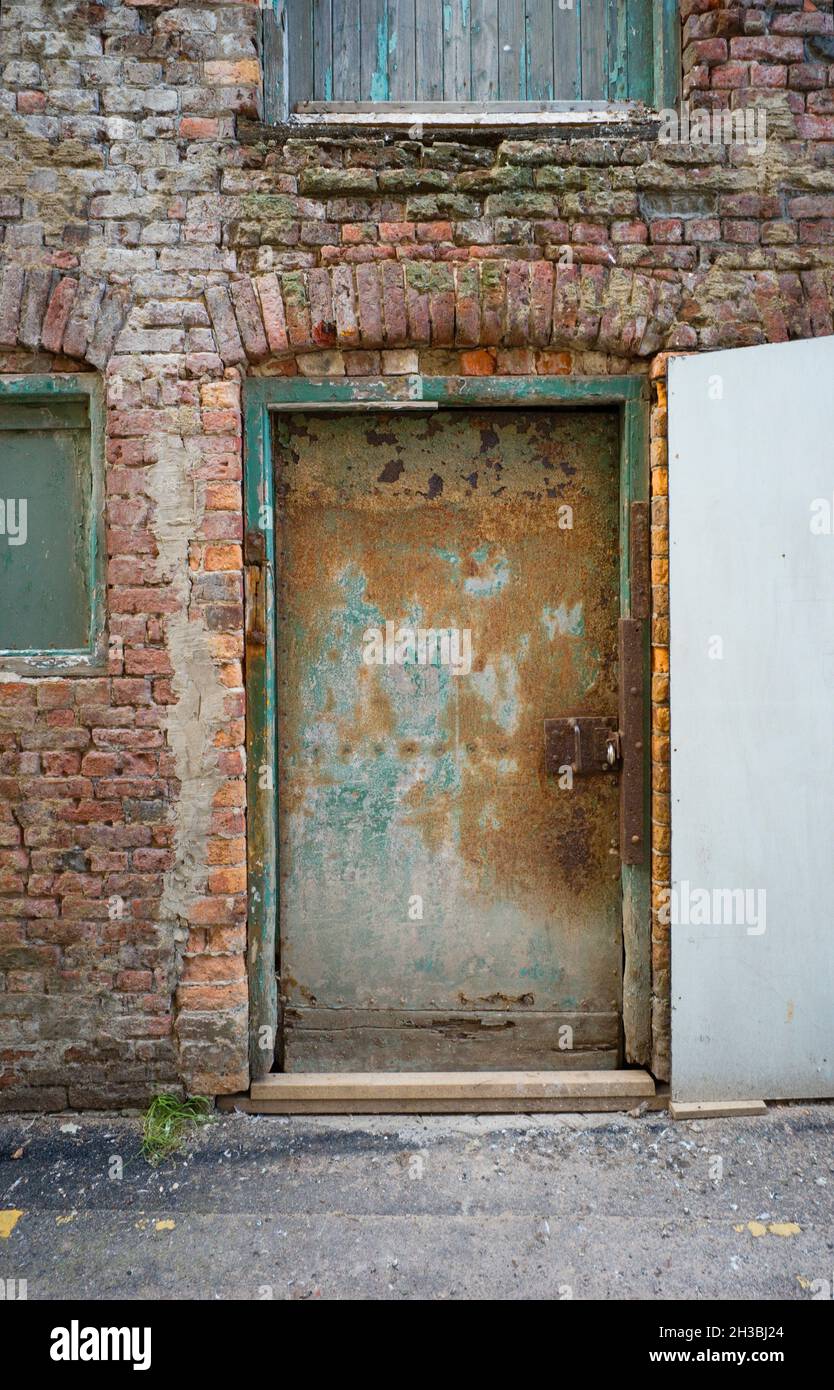 A rusted steel door and heavy duty lock on an abandoned building in the ...
