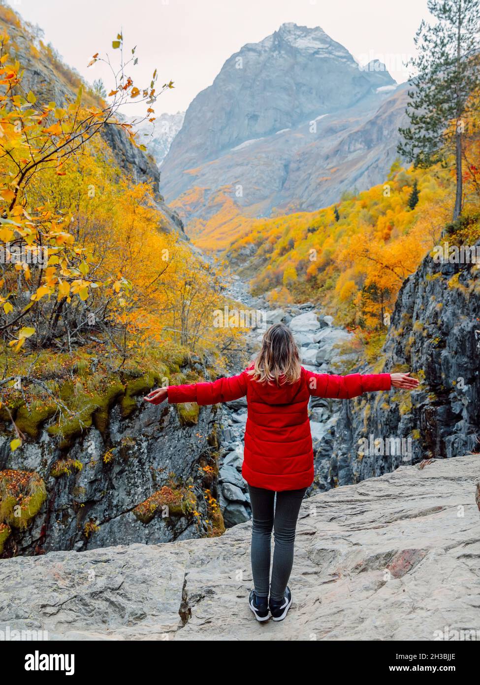 Autumnal fall trees and traveller woman in red jacket. Mountain ...