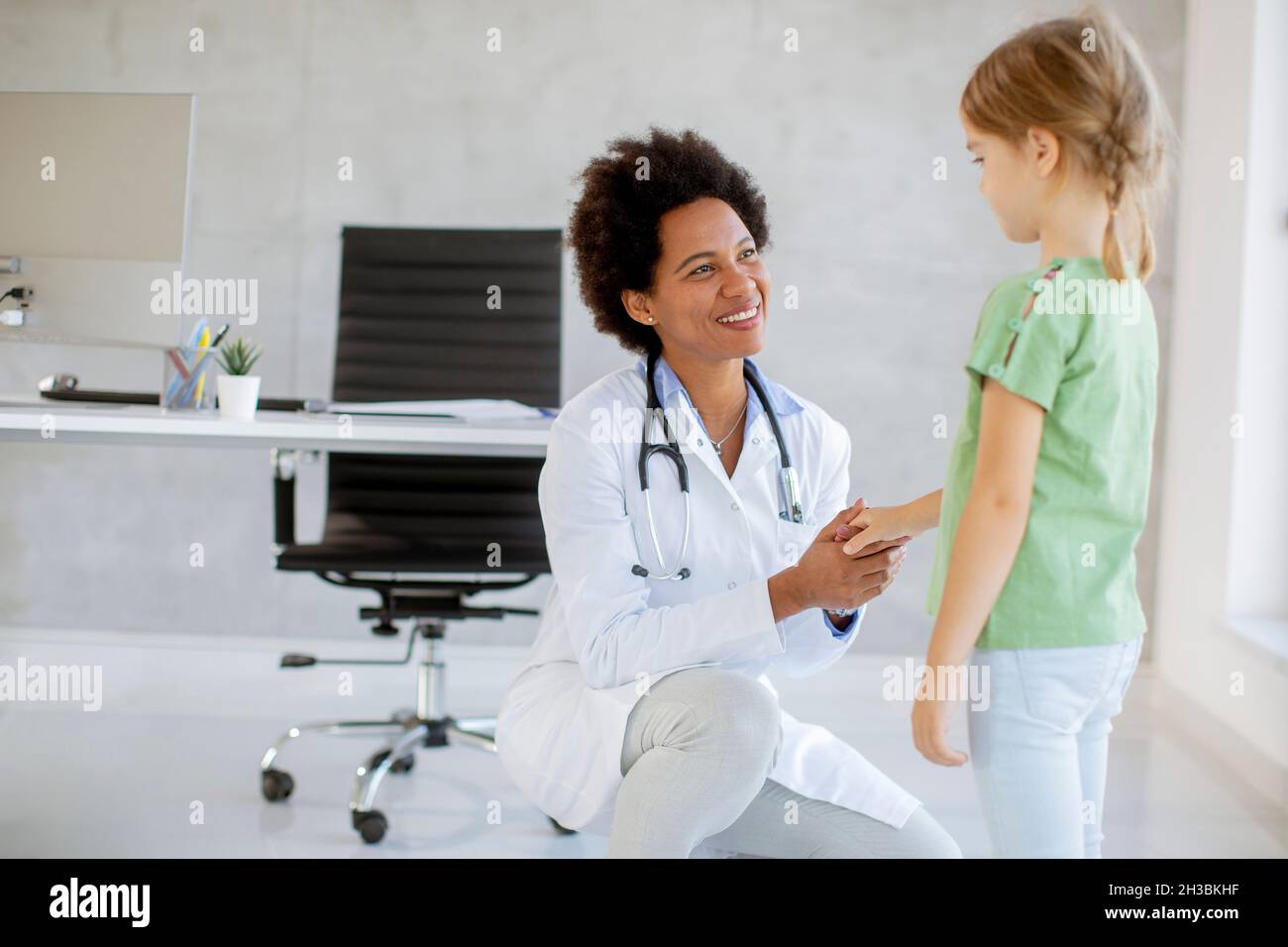 Cute Little Girl At The Pediatrician Examination By African American Cute Little Girl At The Pediatrician Examination By African American