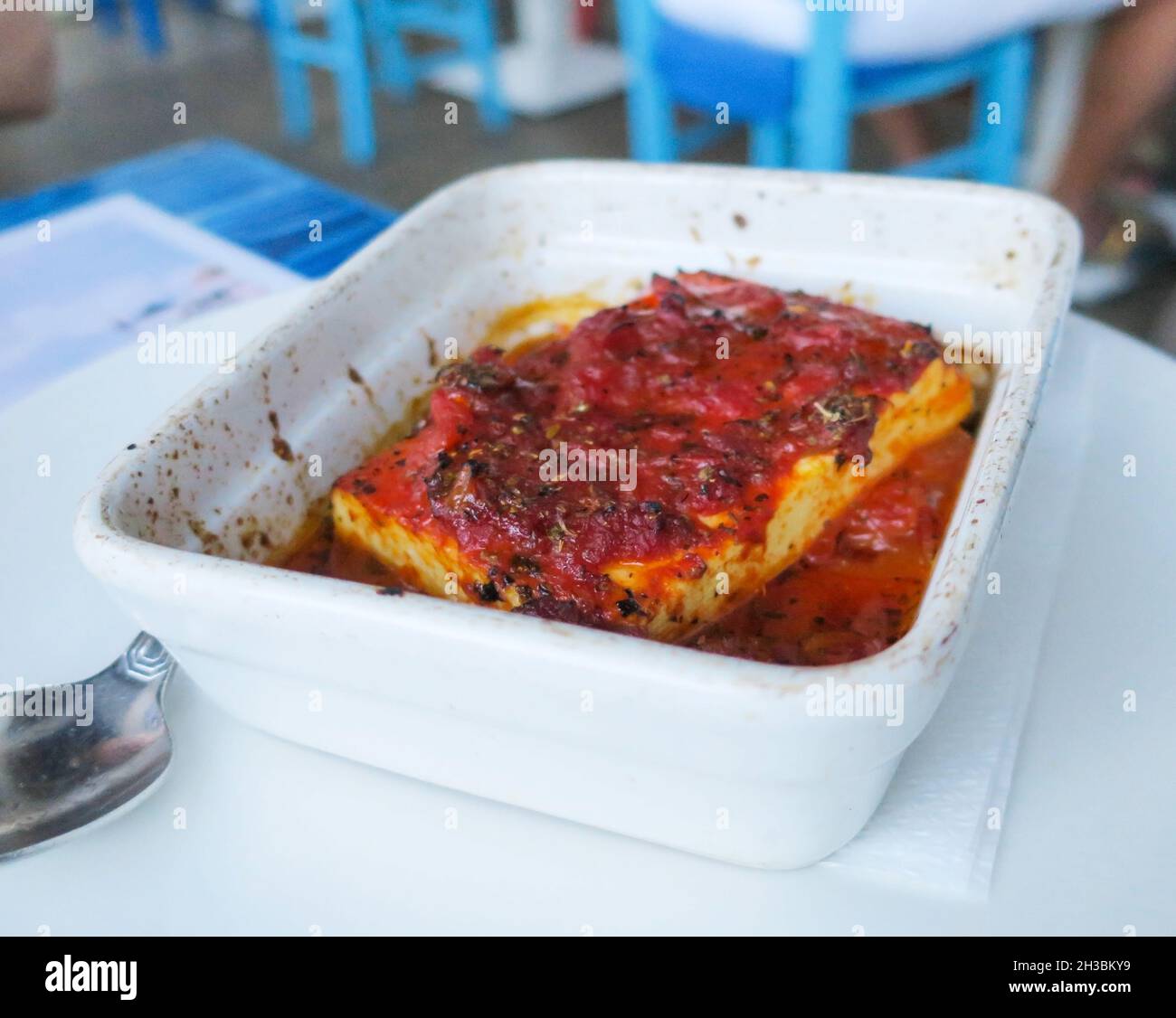 Traditional Cypriot dish - grilled halloumi cheese in tomato sauce in ...