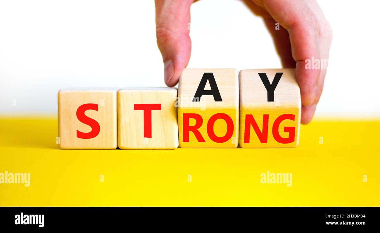 Stay strong symbol. Businessman turns cubes with words 'stay strong ...