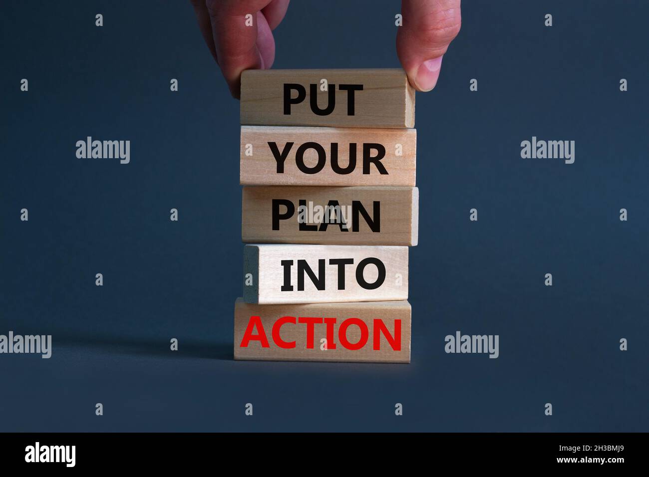 Put your plan into action symbol. Wooden blocks with words Put your ...
