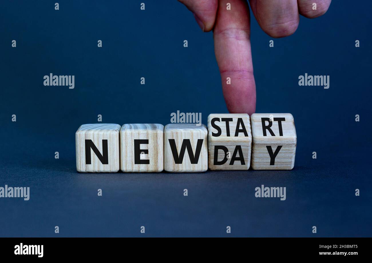 New day and start symbol. Businessman turns wooden cubes and changes ...