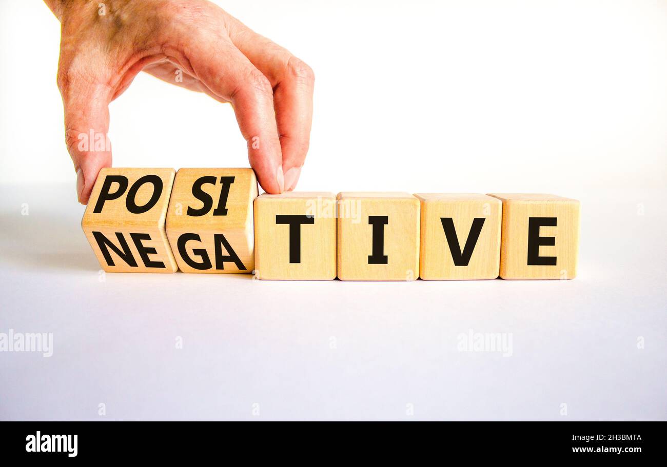 Positive or negative symbol. Businessman turns wooden cubes and changes ...