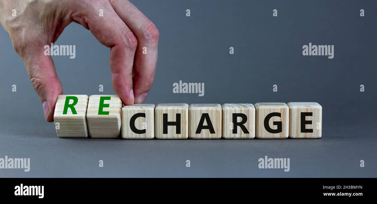 Charge or recharge symbol. Businessman turns wooden cubes and changes ...