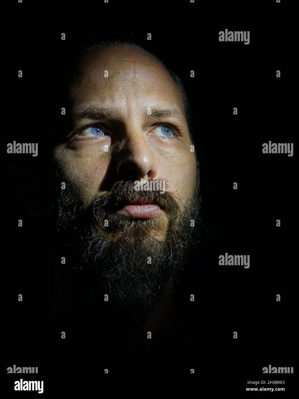 Man portrait. Close up. Face man portrait. lowkey black background ...