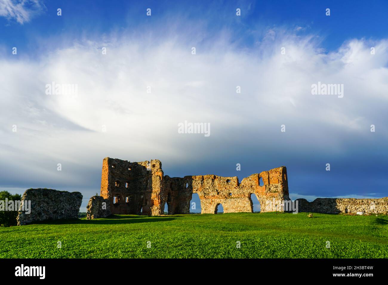 Ludza medieval castle ruins on a background of blue sky and white ...