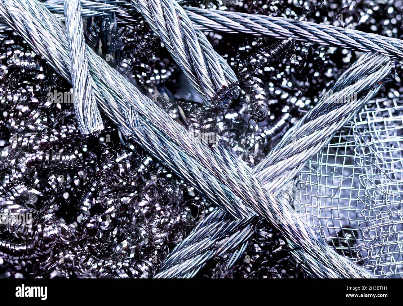 The picture shows a macro shot of several wire ropes, perforated plate ...