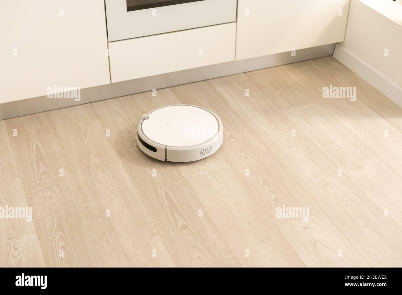 Robotic drone vacuum cleaner on laminate wood floor smart cleaning ...