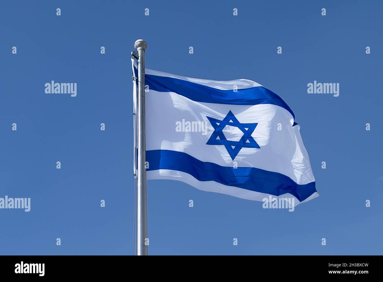 National flag, symbol of Israel in blue and white color blowing in the ...