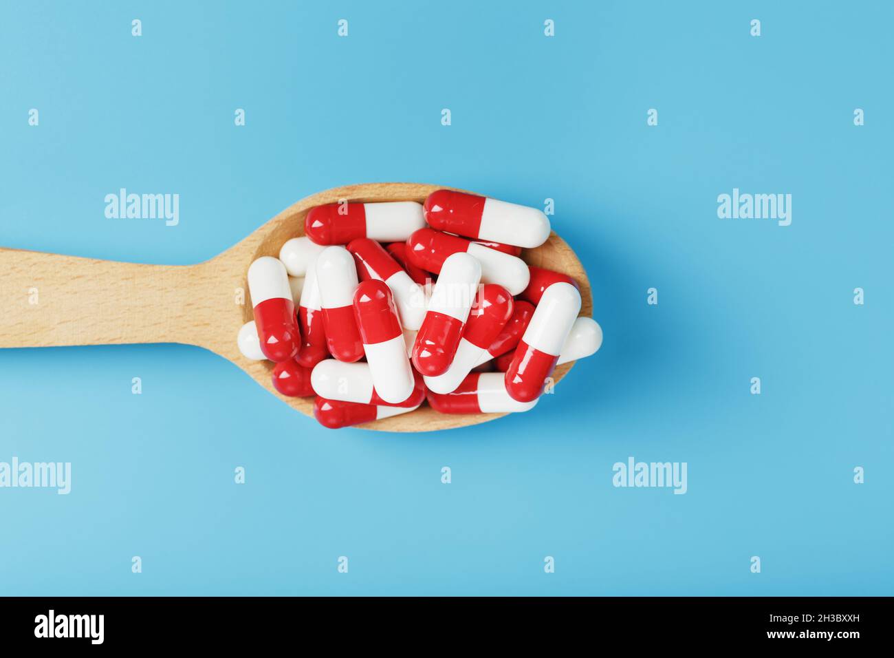 Red and white pill capsules on a blue background. Close-up of Free ...