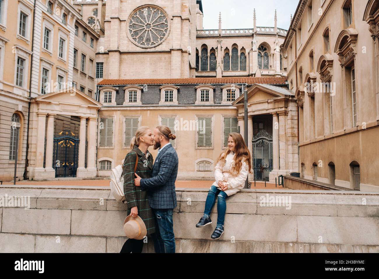 A beautiful family with strolls through the old city of Lyon in France ...