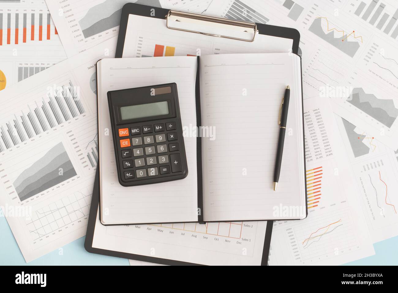 Business graphs, charts and calculator on table. Financial development ...