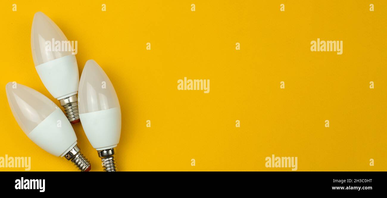 Energy saving and eco friendly LED light bulbs. Yellow background, flat ...