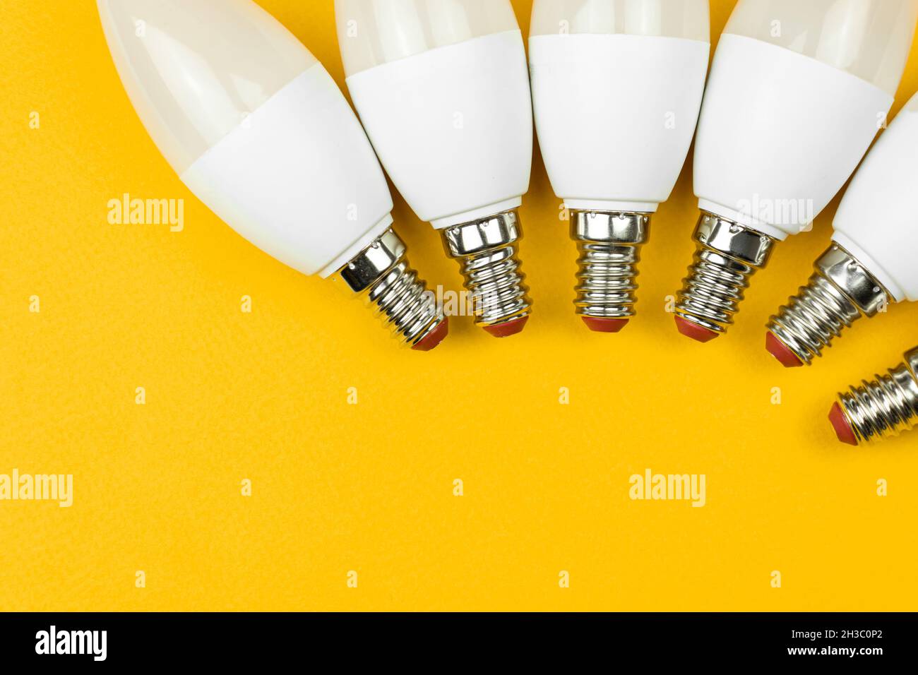 Energy saving LED light bulbs, yellow background. Economical and ...