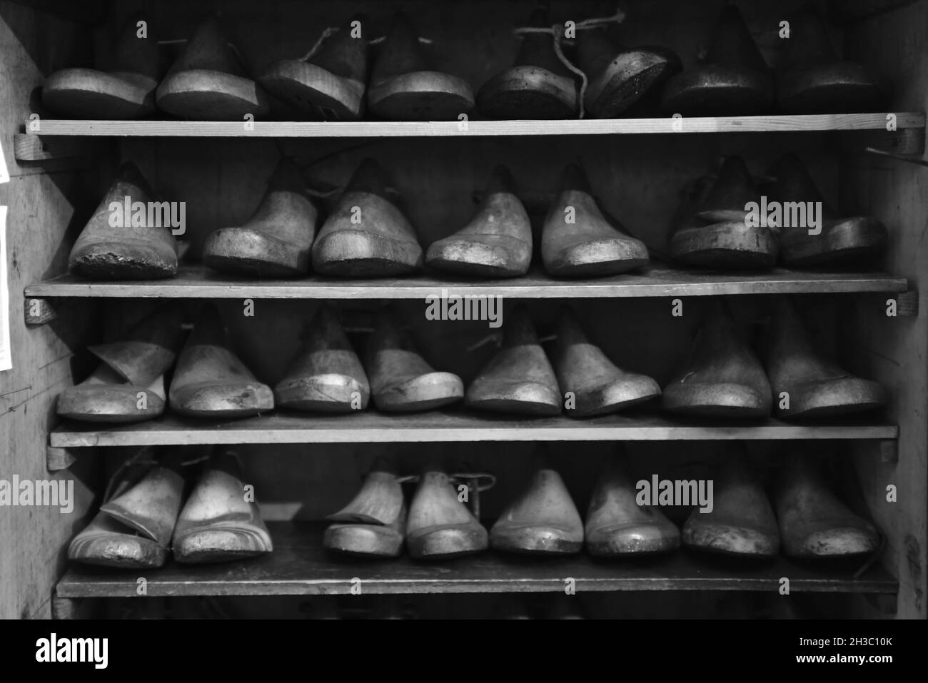 Grayscale shot of shoe forms on shelves Stock Photo - Alamy