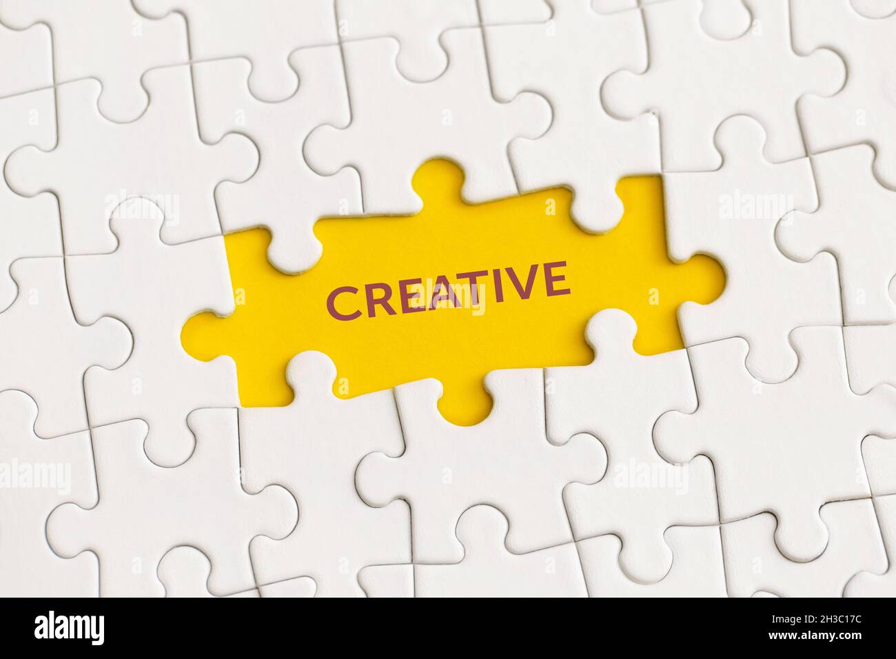 White details of puzzle with the text "Creative" on yellow background ...