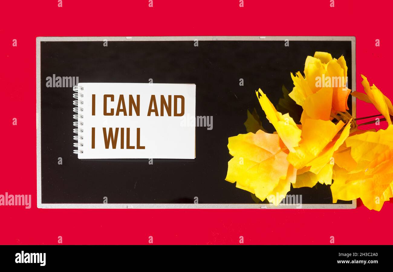 I can and will text written on notepad and black background Stock Photo ...