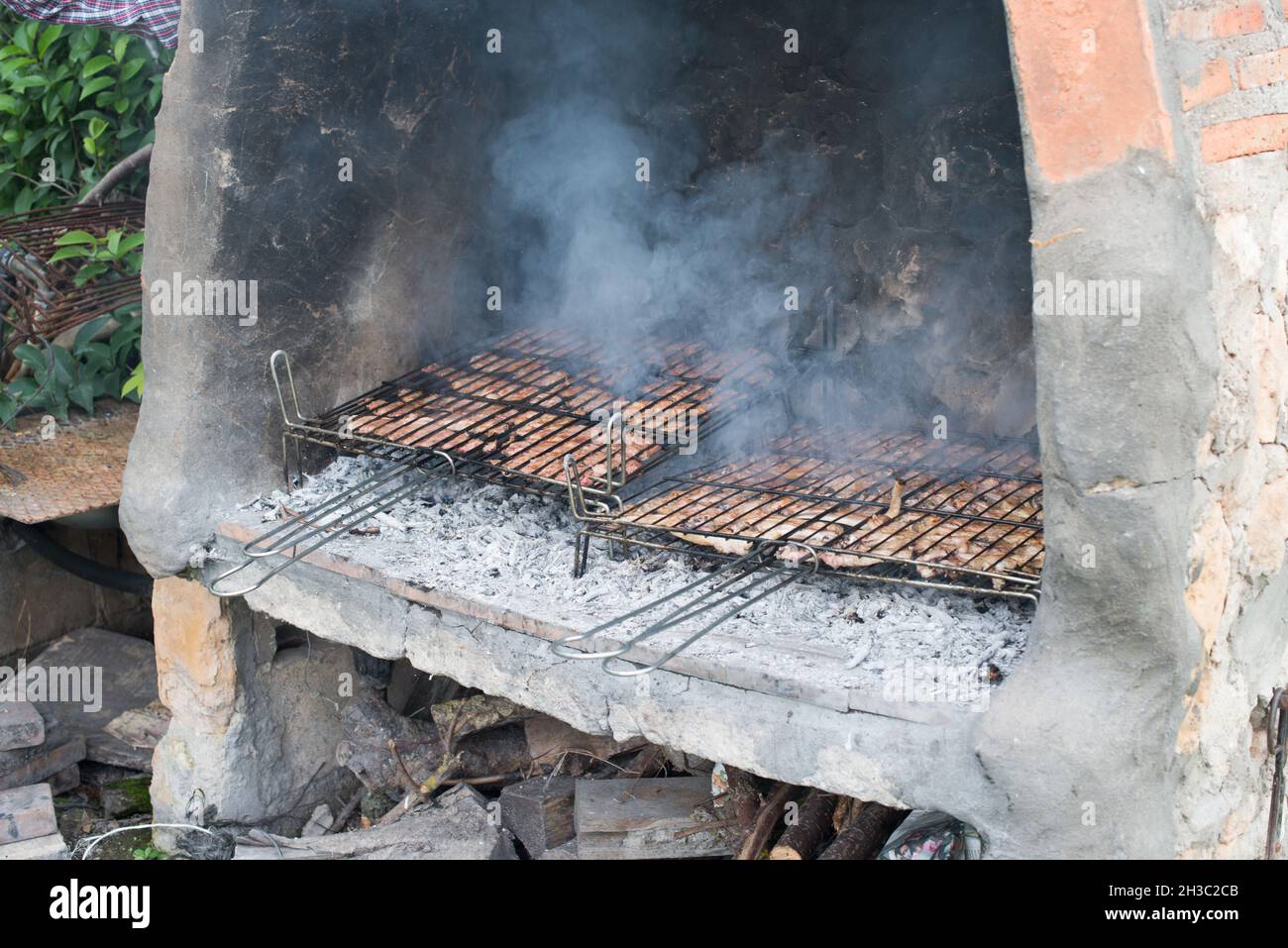 Big barbacue with two cooking grids with lamb chops and pork secret ...