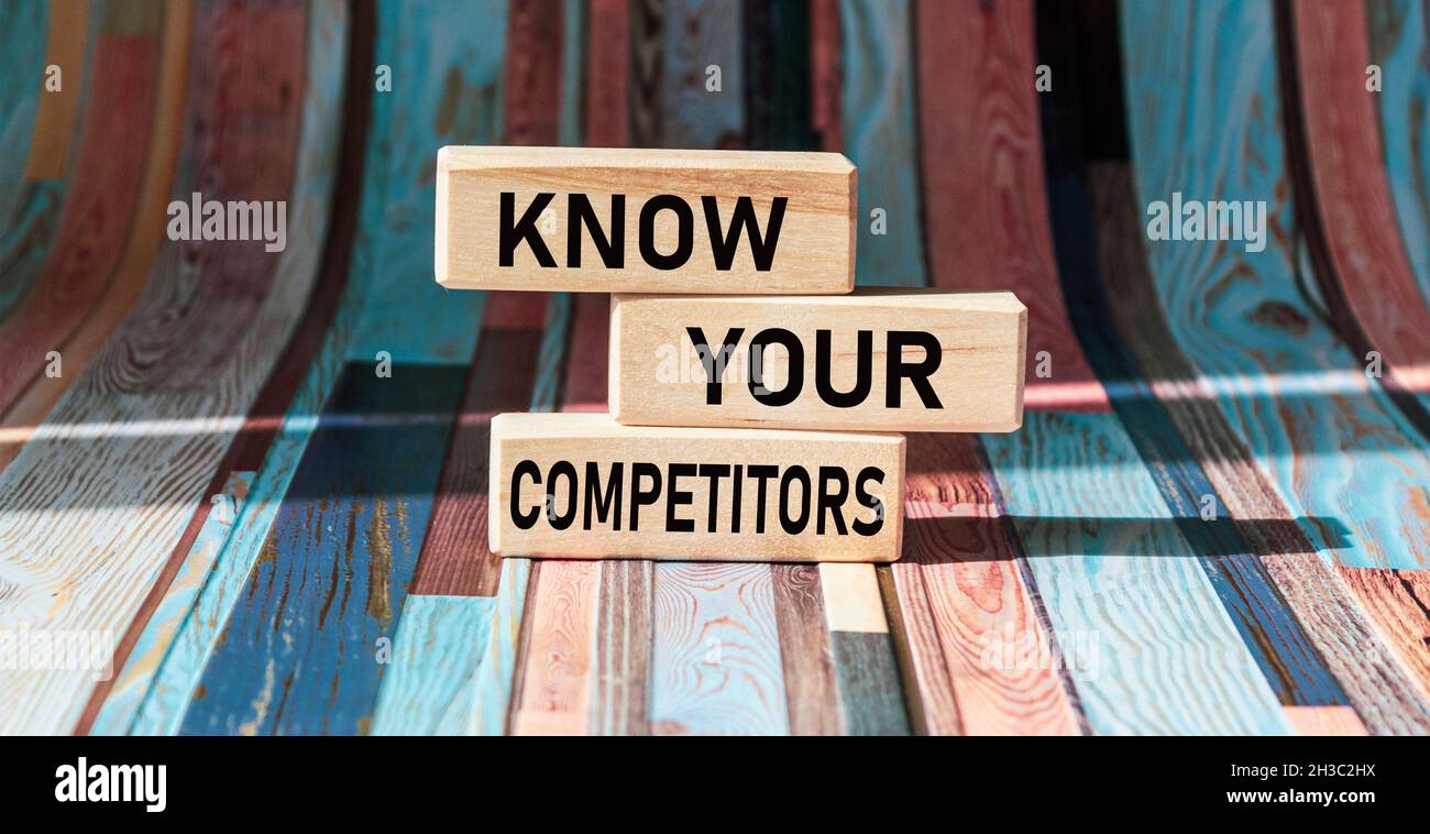 On wooden blocks the text KNOW YOUR COMPETITORS concept of business ...
