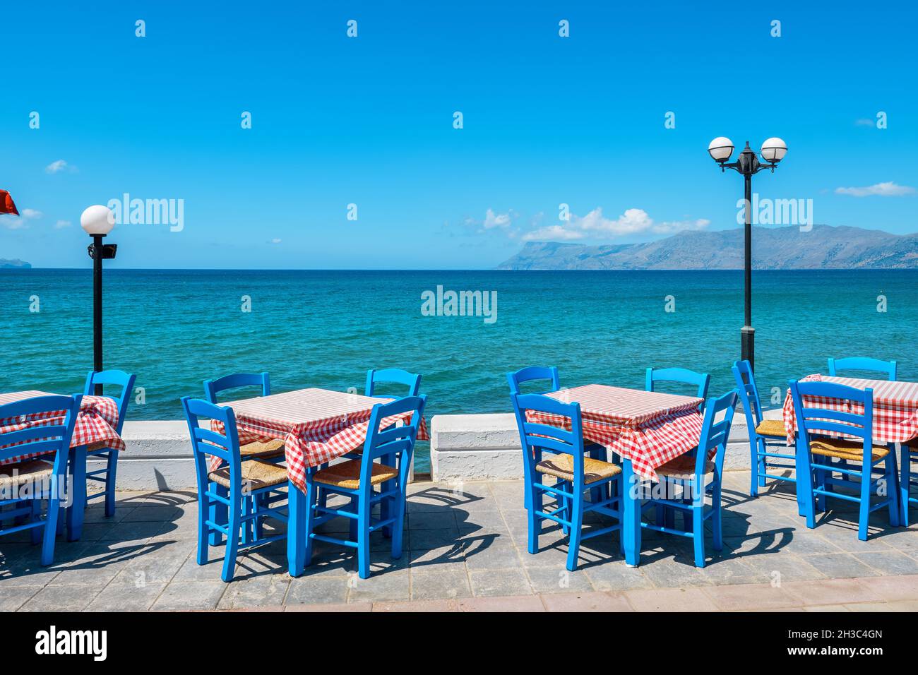 Tables with chairs in traditional Greek taverna in Kissamos town on ...