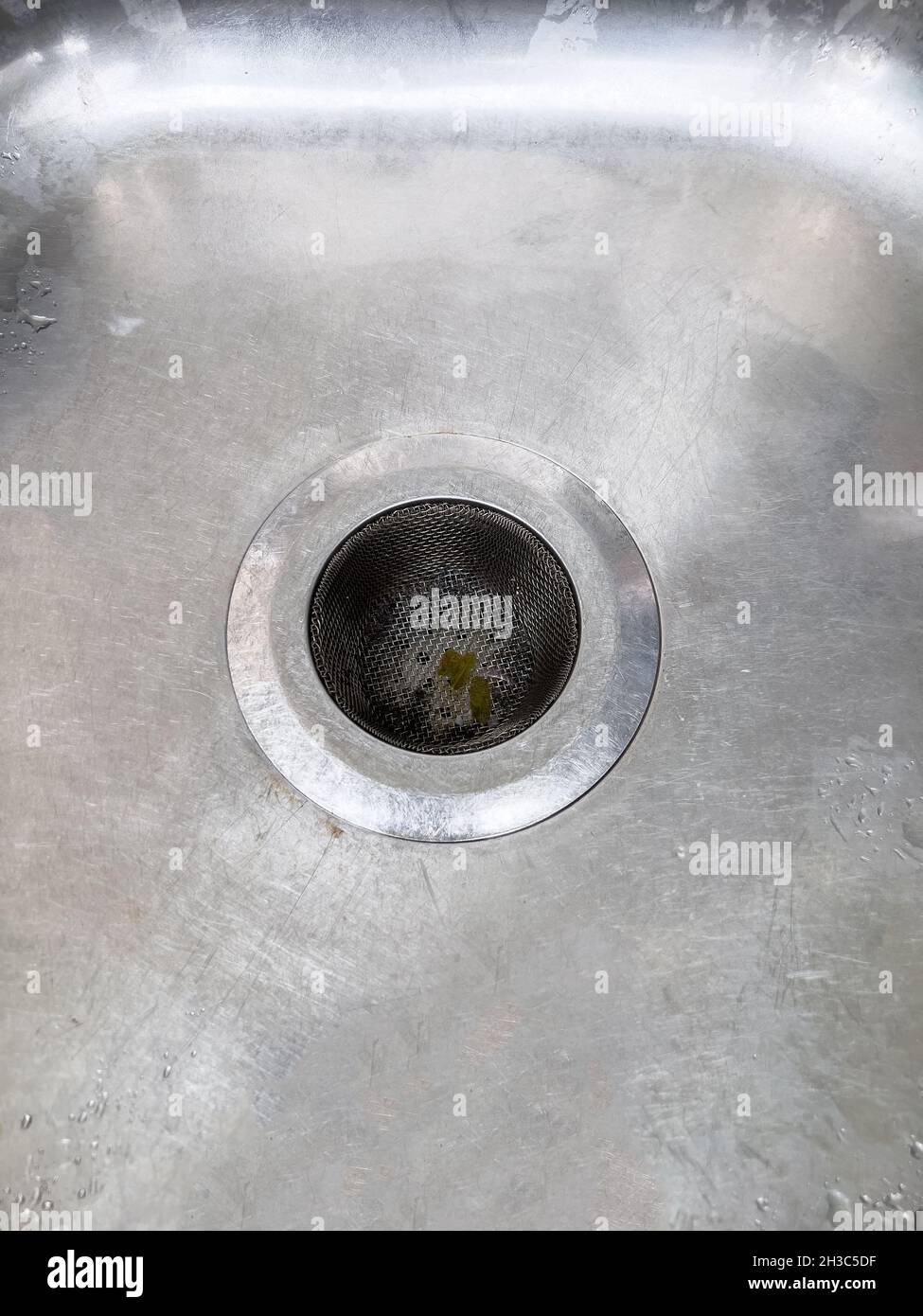Closeup of the stainless steel strainer with the food waste after ...