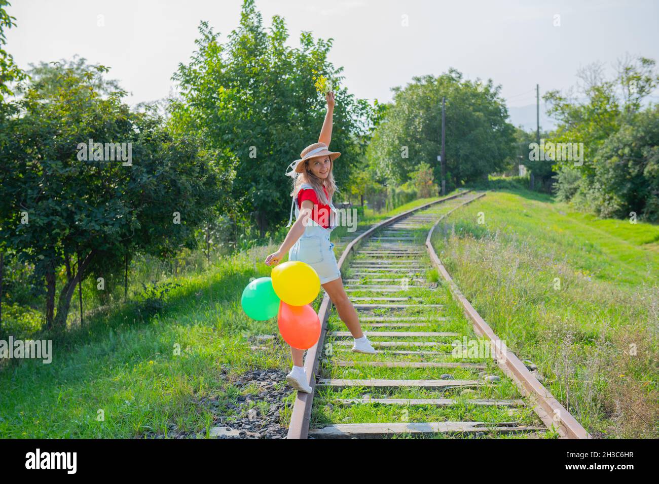 crazy girl jumping with balls on the railroad Stock Photo - Alamy