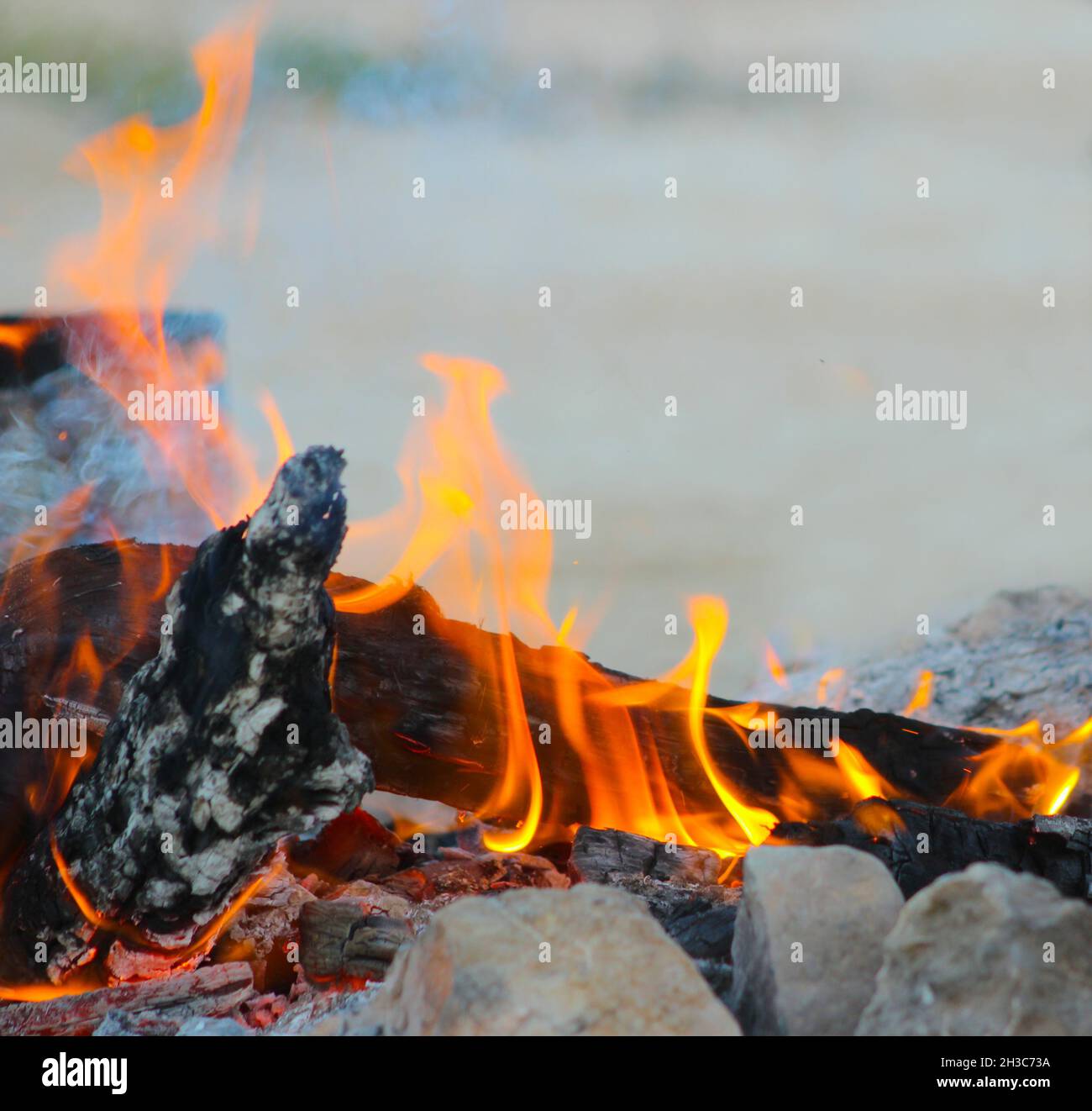 Closeup shot of urning and glowing charcoal with open hot flame and ...