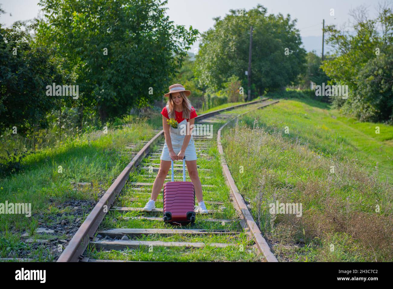 funny traveler walks with a suitcase along the paths Stock Photo - Alamy