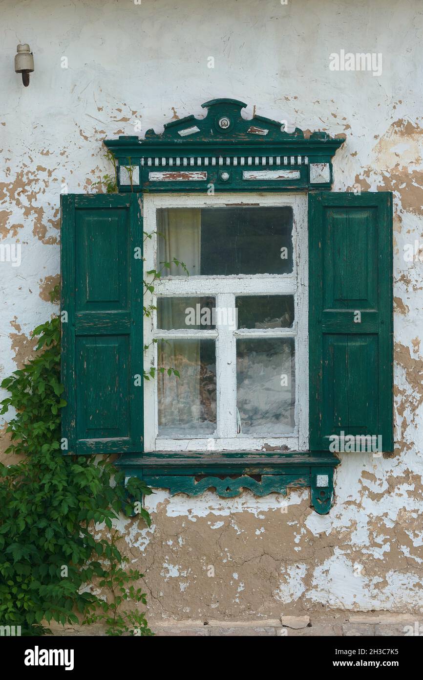 Old wall and window with open wooden shutters in typical style for some ...