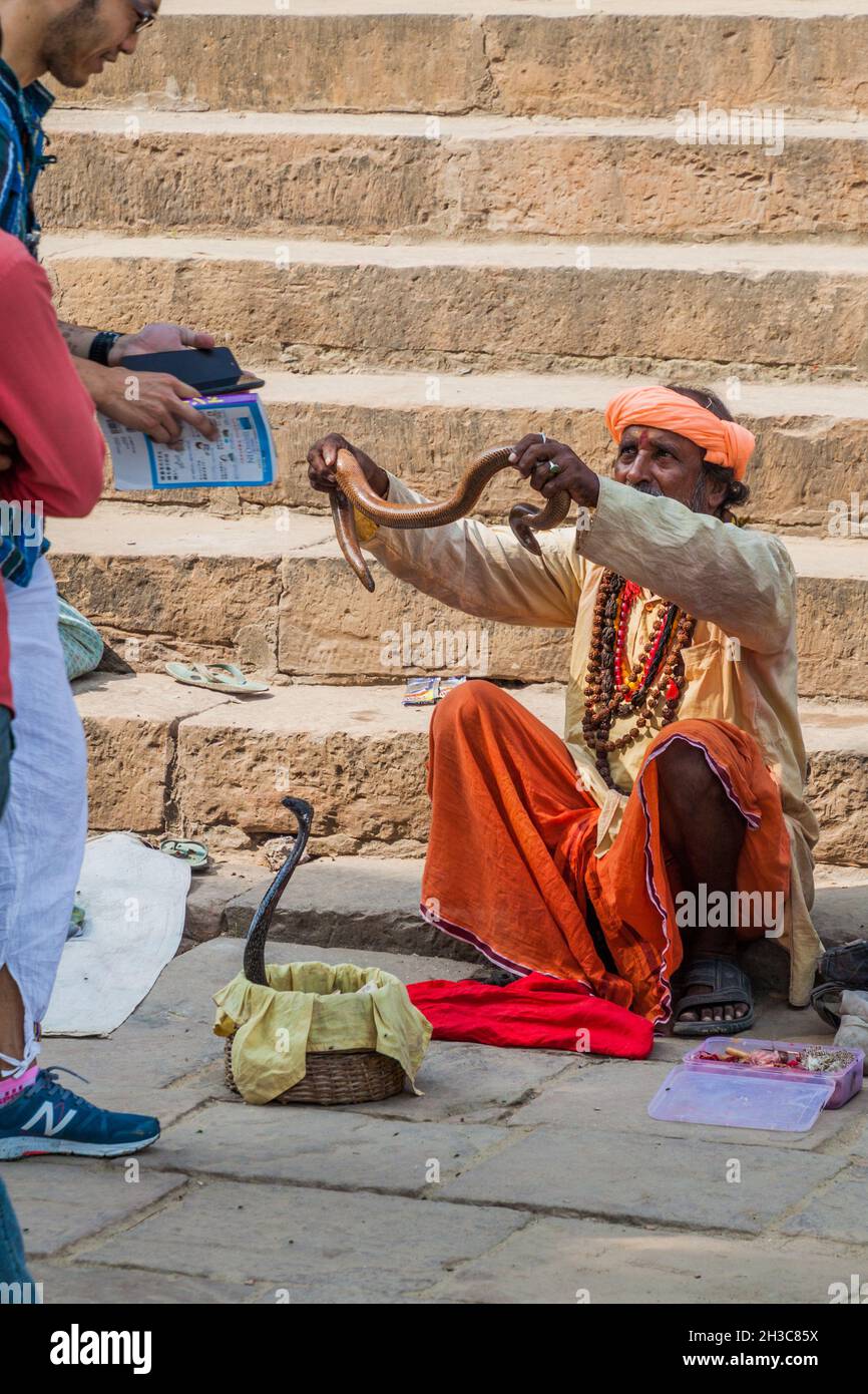 VARANASI, INDIA - OCTOBER 25, 2016: Snake charmer with its cobra at ...
