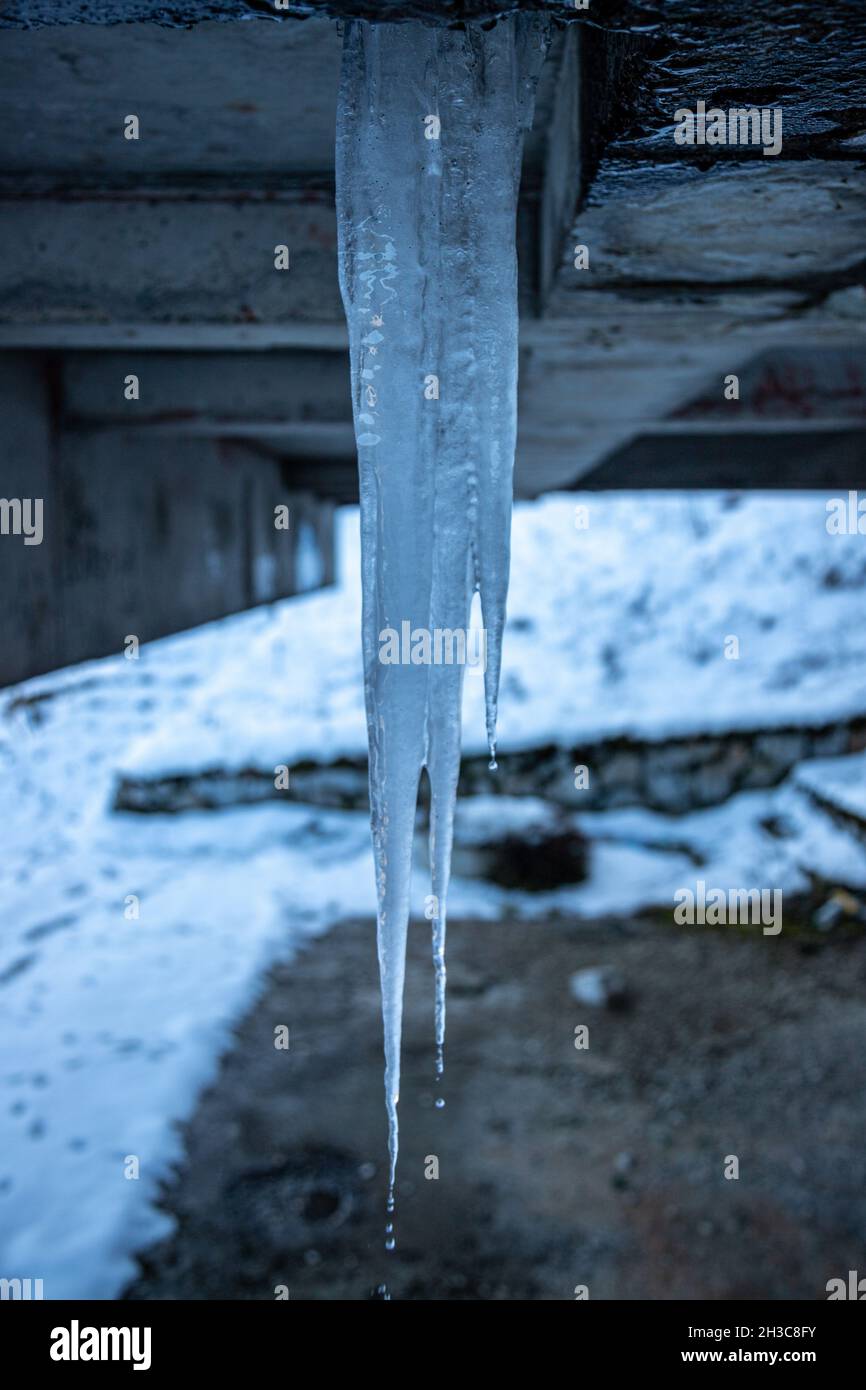 Vertical shot of Icicles hanging off of a building Stock Photo - Alamy