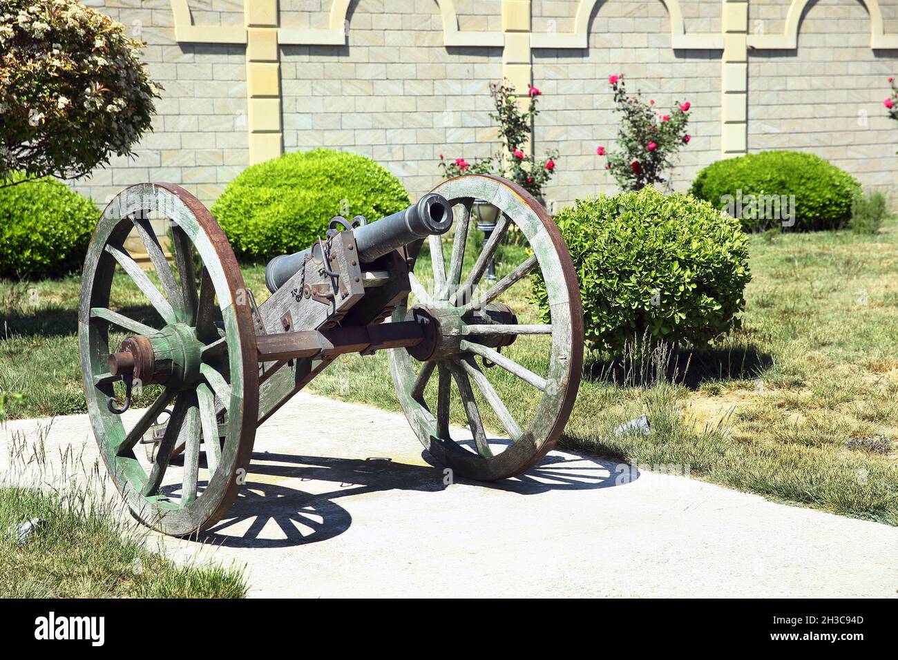 old cannon weapons . old cannon stands in the park in summer ...