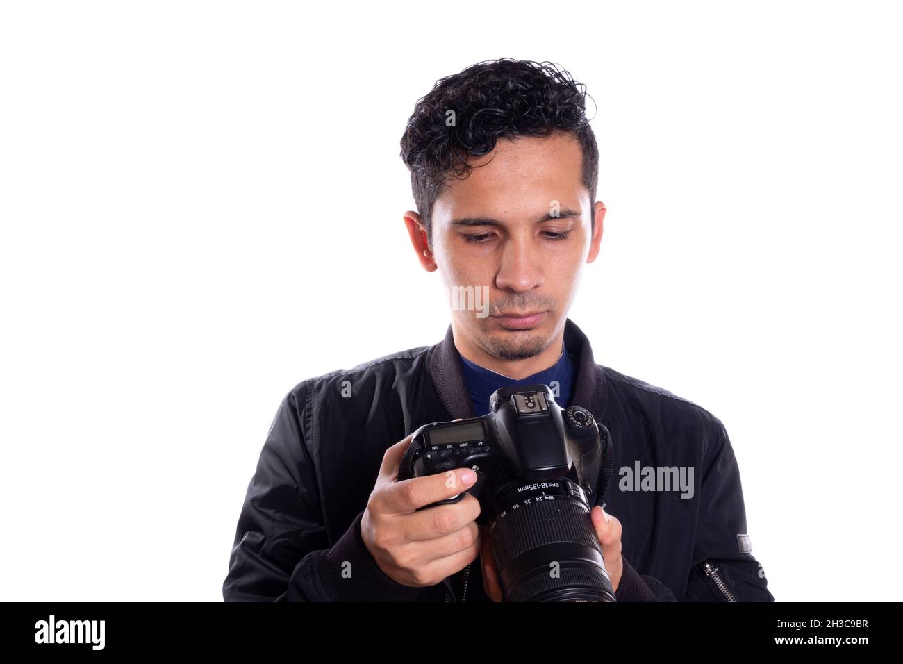 Man looking at his professional camera, isolated on white background ...