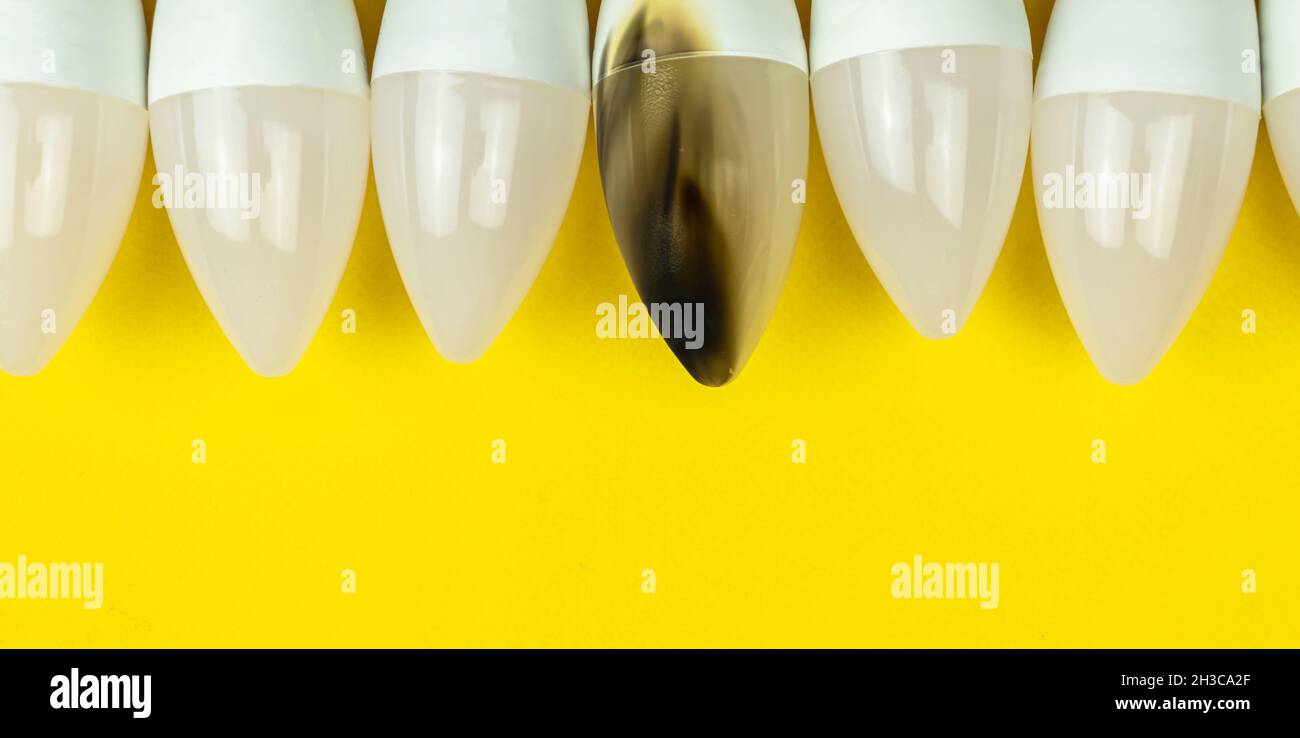 Broken LED light bulb after fire, electrical short circuit concept ...